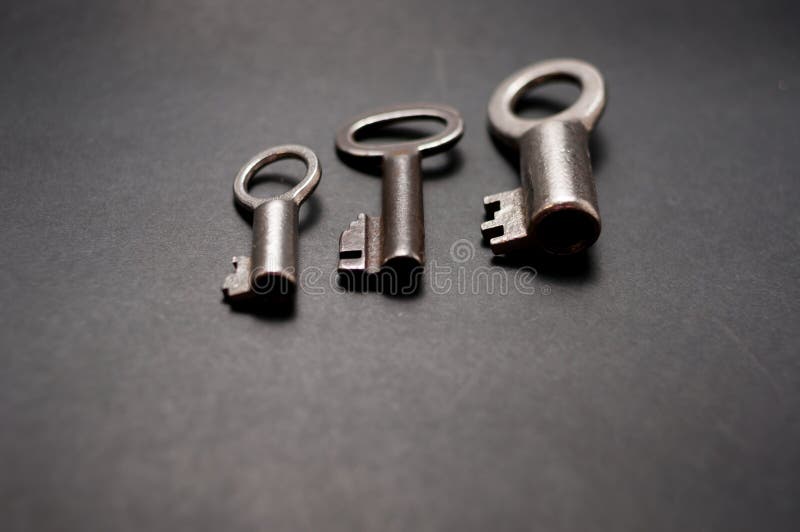 Group of Three Very Small Old Beard Keys on a Black Background. Stock ...