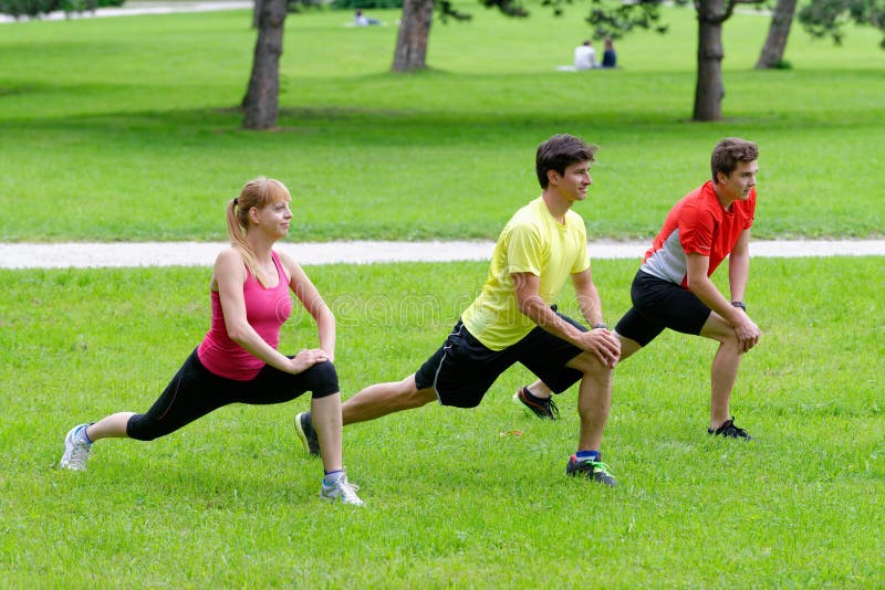 Group of Three Young Athletes Doing Stretching Exercise Stock Image ...