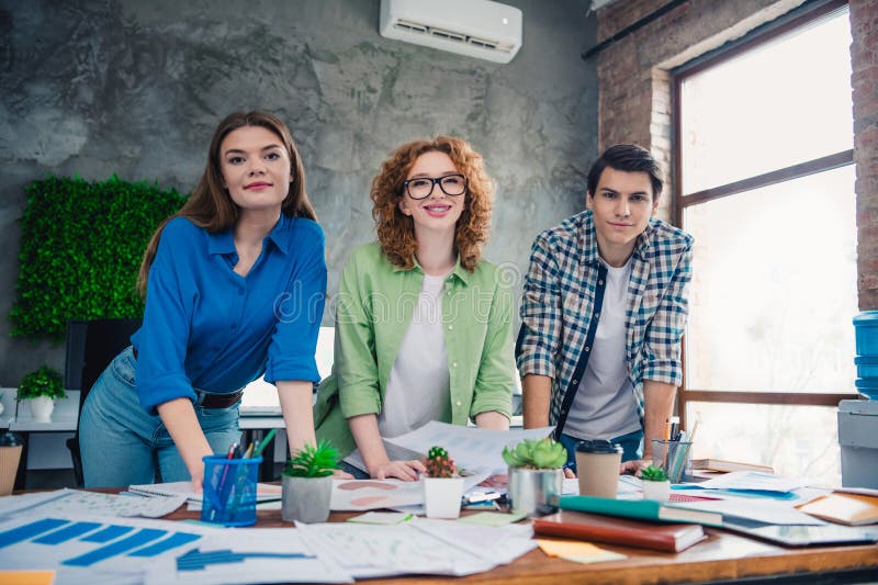 A Group of Three Young Professionals Collaborating in a Modern Office ...