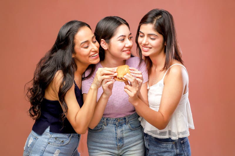 Three Women Having Fun Eating Burger Stock Photos - Free & Royalty-Free ...