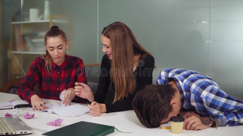 Group of Tired Workers in a Creative Start Up Work Environment Holding ...