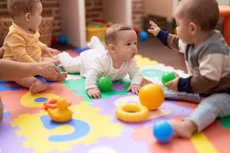 Group of Toddlers Playing with Toys Crawling on Floor at Kindergarten ...