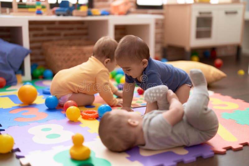 Group of Toddlers Playing with Toys Crawling on Floor at Kindergarten ...