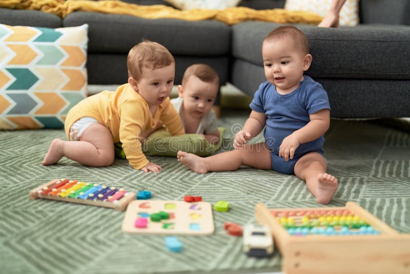 Group of Toddlers Playing with Toys Sitting on Floor at Home Stock ...