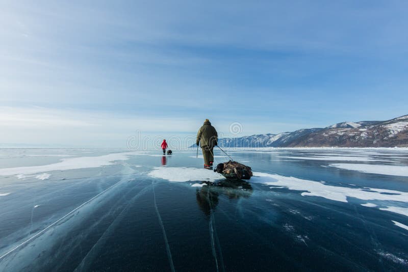 Group of Tourists with Ice Sleds Walking Along the Ice of Lake Baikal ...