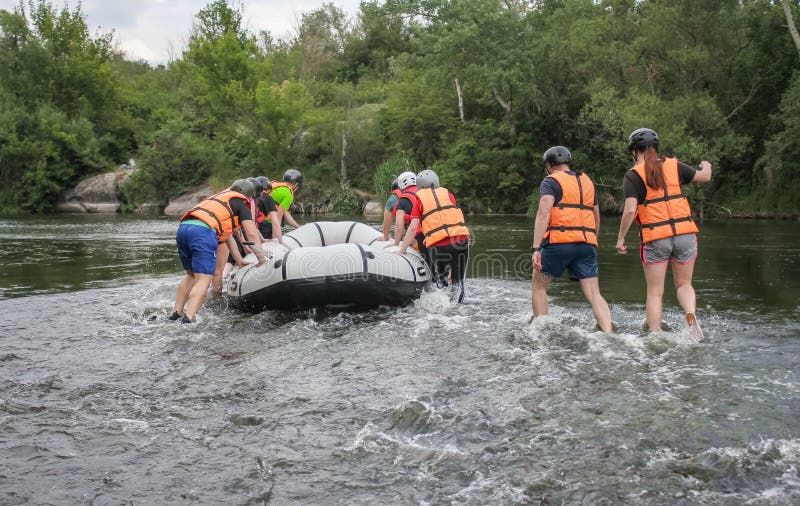 A Group of Tourists Leads the Boat on a Small Section of the River ...