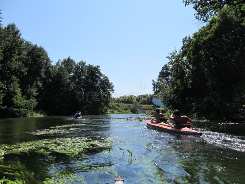 Rafting - Mature Woman in Black Swimsuit Standing on Swimming Raft ...