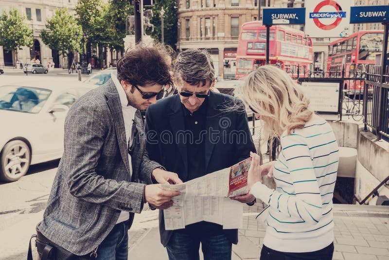 Group of Tourists Standing at Trafalgar Square and Looking at Map ...