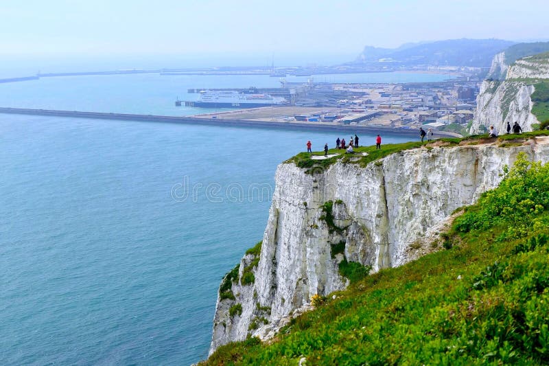 A Group of Tourists on the White Cliff with the Port in the Background ...