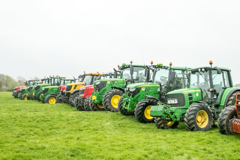 A Group of Tractors Parked Up Editorial Photo - Image of exhaust, blue ...