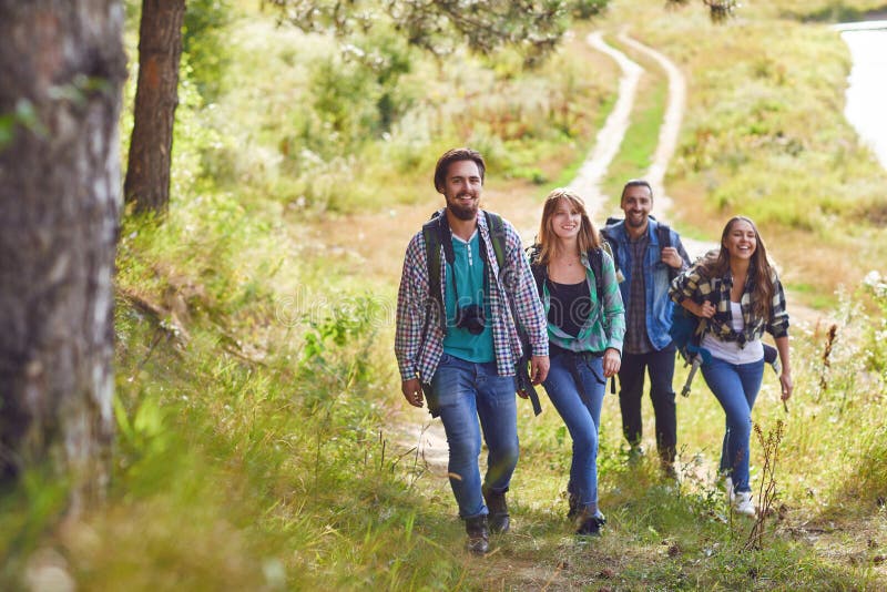 A Group of Travelers with Backpacks is Walking in Nature Stock Image ...