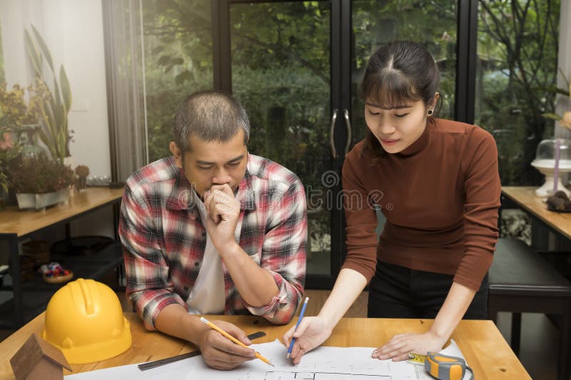 Group of Two Coworkers Working with Blueprint in Office. Co-working ...