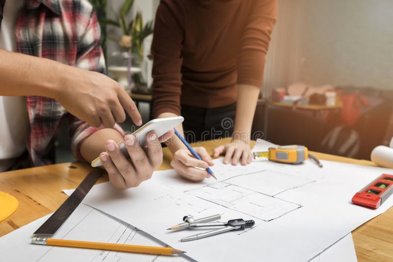 Group of Two Coworkers Working with Blueprint in Office. Co-working ...