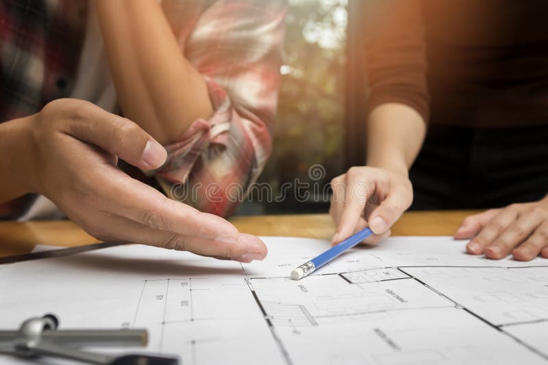 Group of Two Coworkers Working with Blueprint in Office. Co-working ...