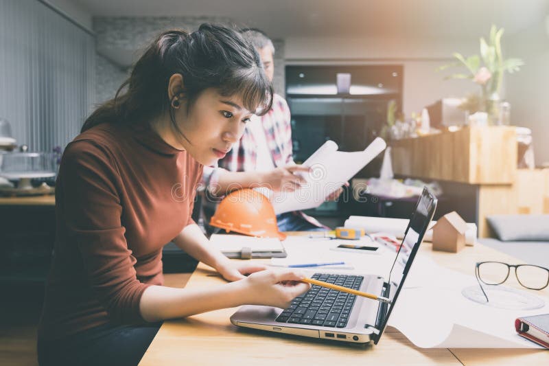 Group of Two Coworkers Working with Blueprint in Office. Co-working ...