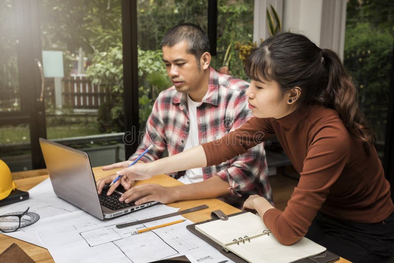 Group of Two Coworkers Working with Blueprint in Office. Co-working ...