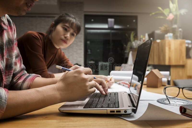 Group of Two Coworkers Working with Blueprint in Office. Co-working ...