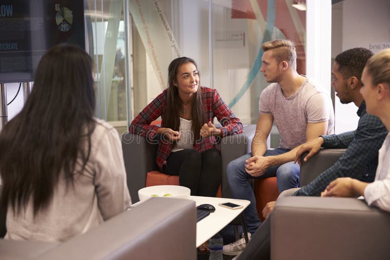 Group of University Students Discussing Project Together Stock Photo ...