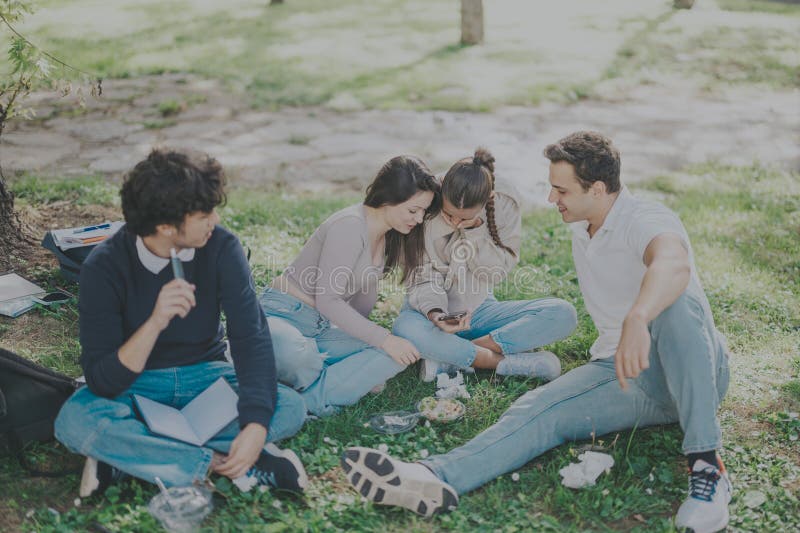 Group of University Students Enjoying Quality Time Together Outdoors ...