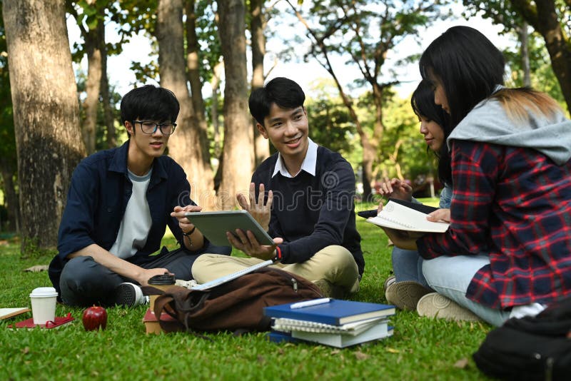 Group of University Students Learning Together while Sitting Under the ...