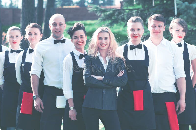 Group of Waiters in the Branded Clothes are on the Lawn in Front Stock ...