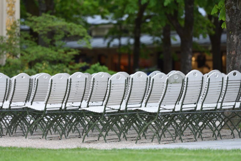 A Group of White Chairs, Standing Outside in the Park in Front of the ...