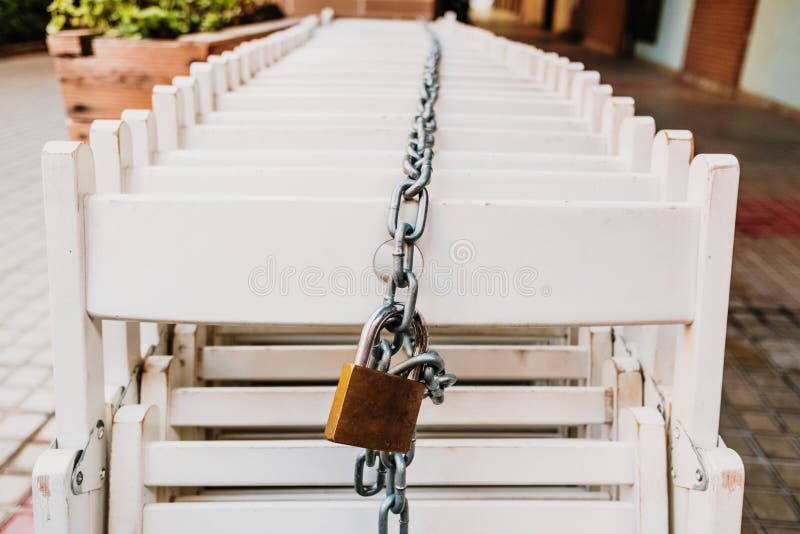 Group of White Chairs Tied with a Chain and Padlock Stock Image - Image ...