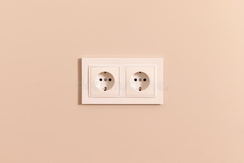 Electrical Outlets on Beige Wall Stock Photo - Image of socket ...