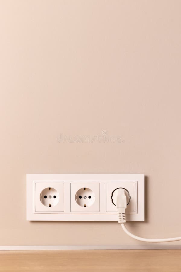 Electrical Outlets with Plug on Beige Wall Stock Image - Image of cable ...