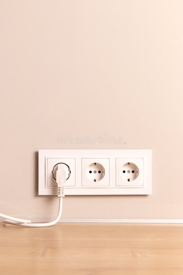 Electrical Outlets with Plug on Beige Wall Stock Image - Image of ...