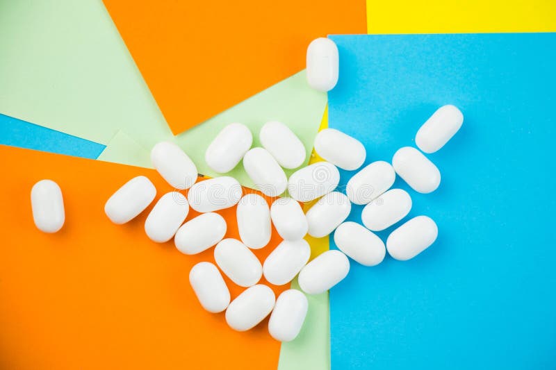 Group of White Hard Candies Arranged Neatly on a Vibrant-colored ...