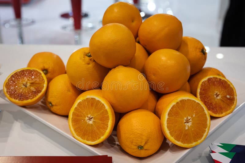 Group of Whole Oranges and Some Oranges Cut in Half Inside a White ...