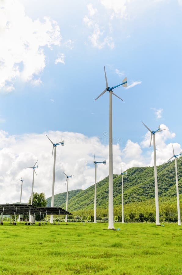 Group of Wind Turbines on Green Hillside Stock Photo - Image of hilltop ...