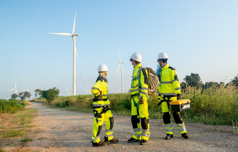 Group of Wind Turbine or Windmill Workers or Technicians Stand on the ...