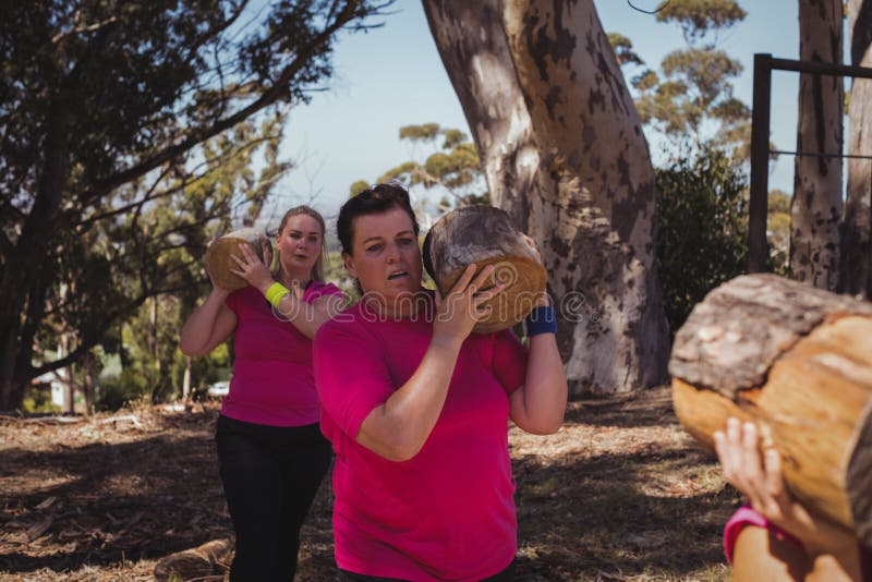 Group of Women Carrying a Heavy Wooden Log during Obstacle Course Stock ...