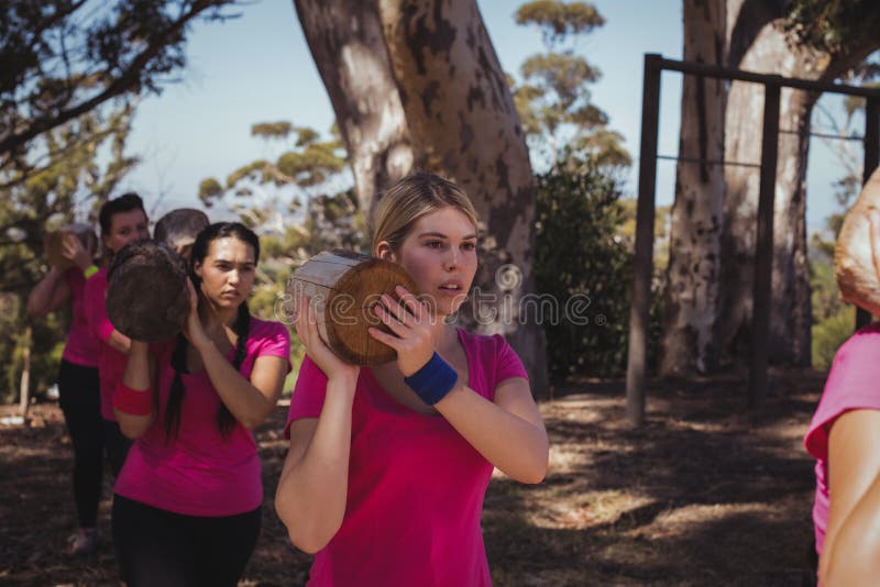 Group of Women Carrying a Heavy Wooden Log during Obstacle Course Stock ...