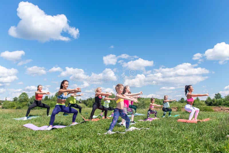 Group of Women Exercising and Doing Squats at Boot Camp. Stock Photo ...