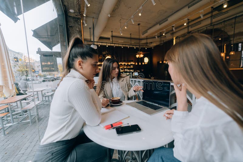 A Group of Women Friends in a Cafe Working on a Project Stock Image ...