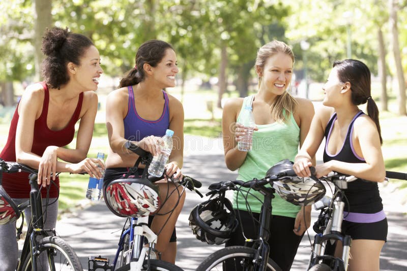 Group of Women Resting during Cycle Ride through Park Stock Photo ...