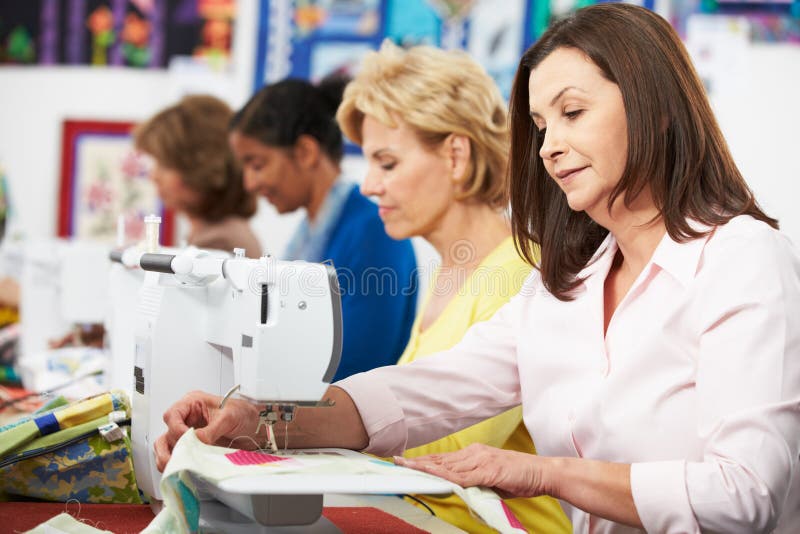 Group of Women Using Electric Sewing Machines in Class Stock Photo ...