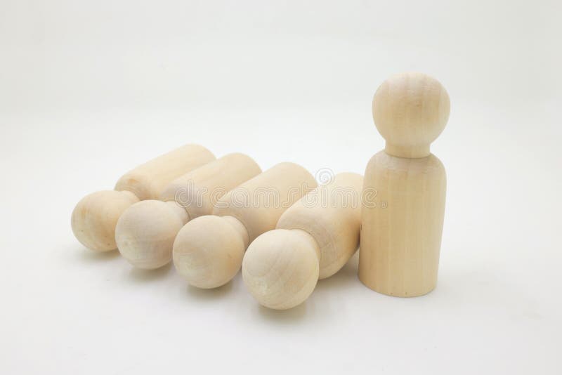 A Group of Wooden Figures, One Leader is Standing Stock Image - Image ...