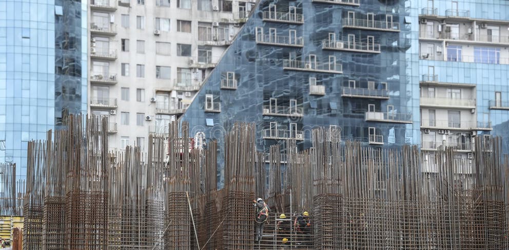 Group of Workers Assembling Framework of Building from Iron Fittings ...