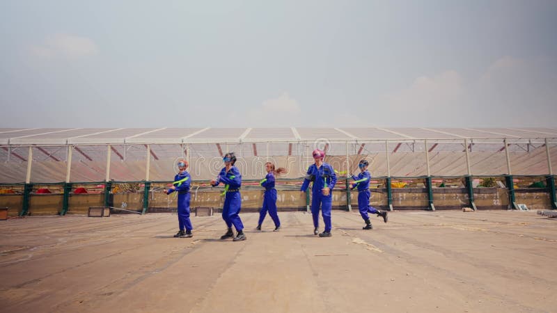 Diverse Group of Workers in Blue Uniforms Dancing Confidently on ...
