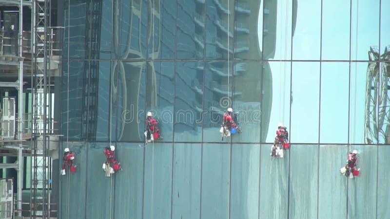 High Maintenance Workers Installing a Window on the Exterior of a ...