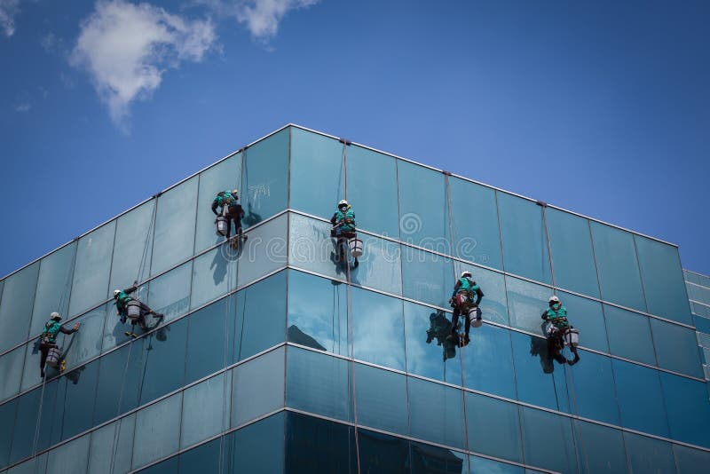 Group of Workers Cleaning Windows Service on High Rise Building Stock ...
