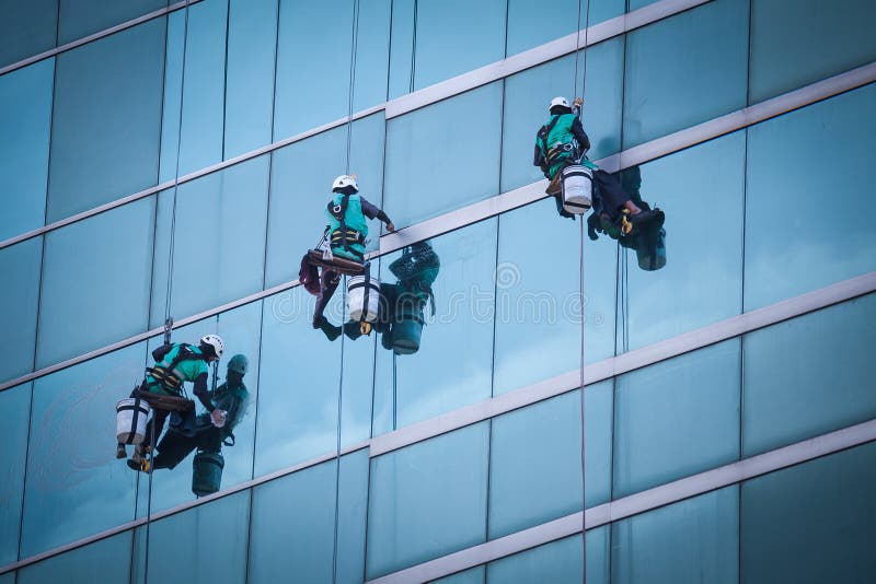 Group of Workers Cleaning Windows Service on High Rise Building Stock ...