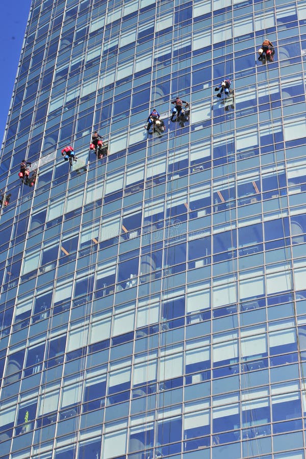 Group of Workers Cleaning Windows Service on High Rise Building ...