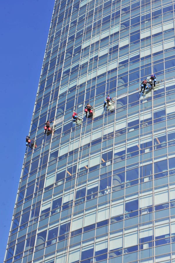Group of Workers Cleaning Windows Service on High Rise Building ...