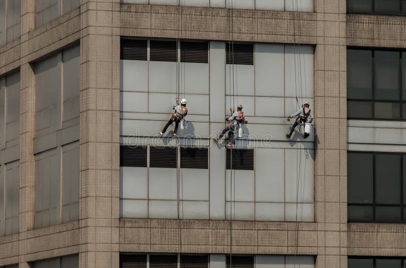 Group of Workers Cleaning Windows Service on High Rise Office Building ...