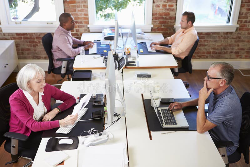 Workers at Desks in Busy Creative Office Stock Image - Image of african ...